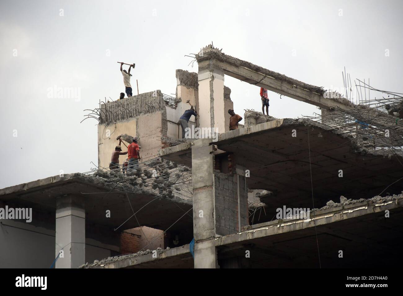 DHAKA, BANGLADESH– 21 October 2020: Bangladeshi worker uses a sledge ...