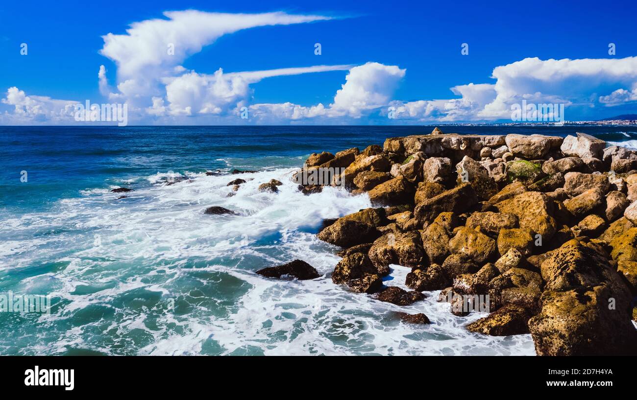 Drone photo of rocky pier or breakwater in the blue ocean. Costa Da ...