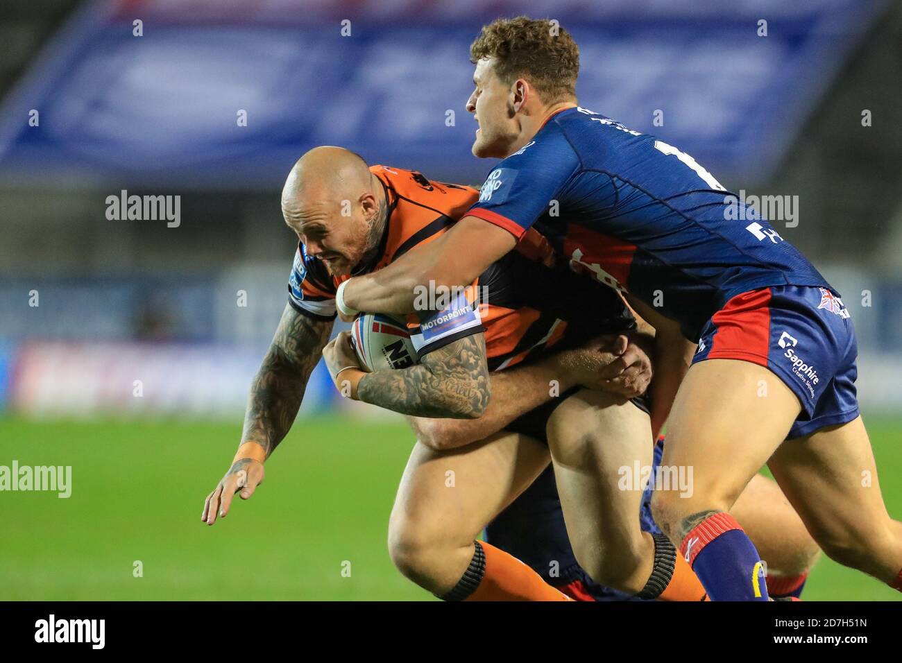 Nathan Massey (14) of Castleford Tigers punches a hole in the defence ...