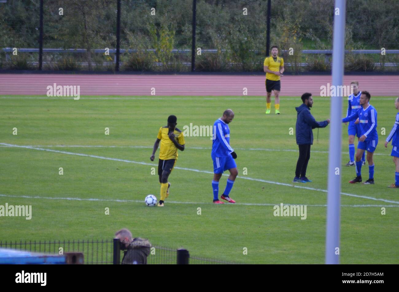 Mixed group playing football at stadium Stock Photo - Alamy