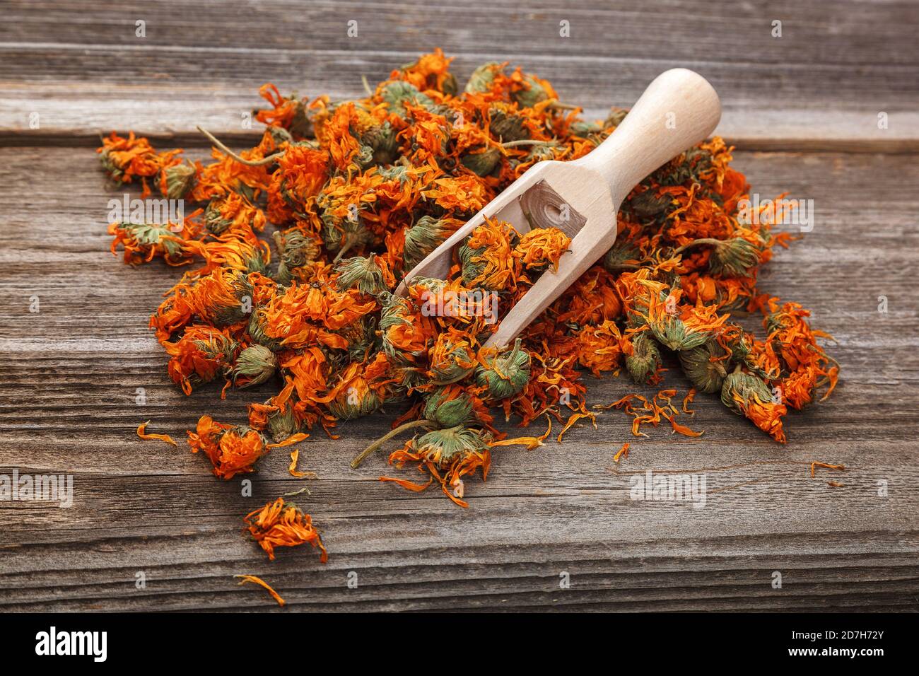 Dried calendula flowers on wooden background. Medicinal plants Stock ...