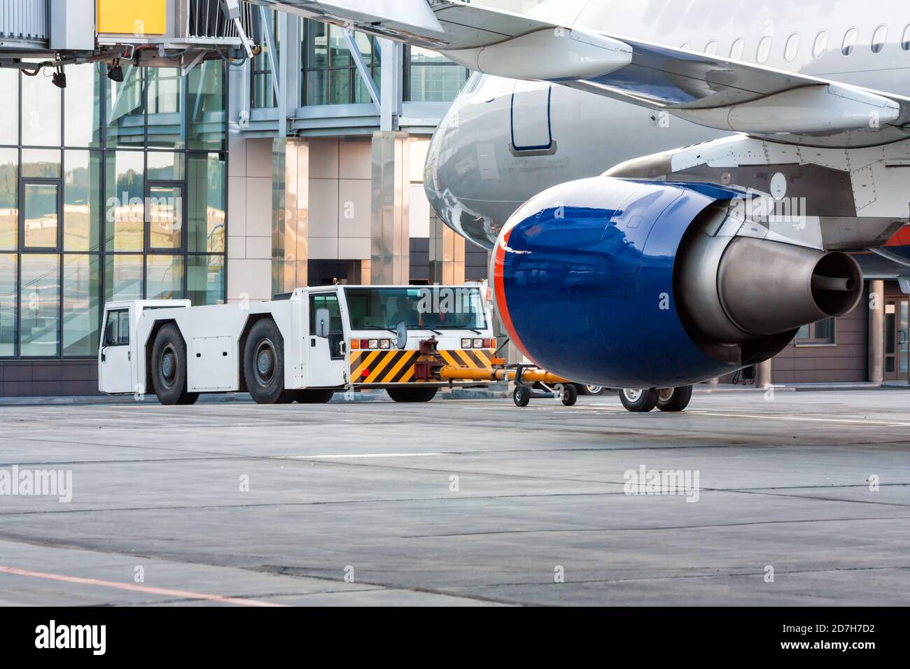 The tractor is towing the passenger airplane Stock Photo - Alamy