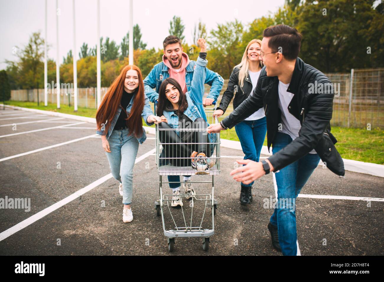 Wild youth. Group of four young diverse friends in jeanse outfit look ...