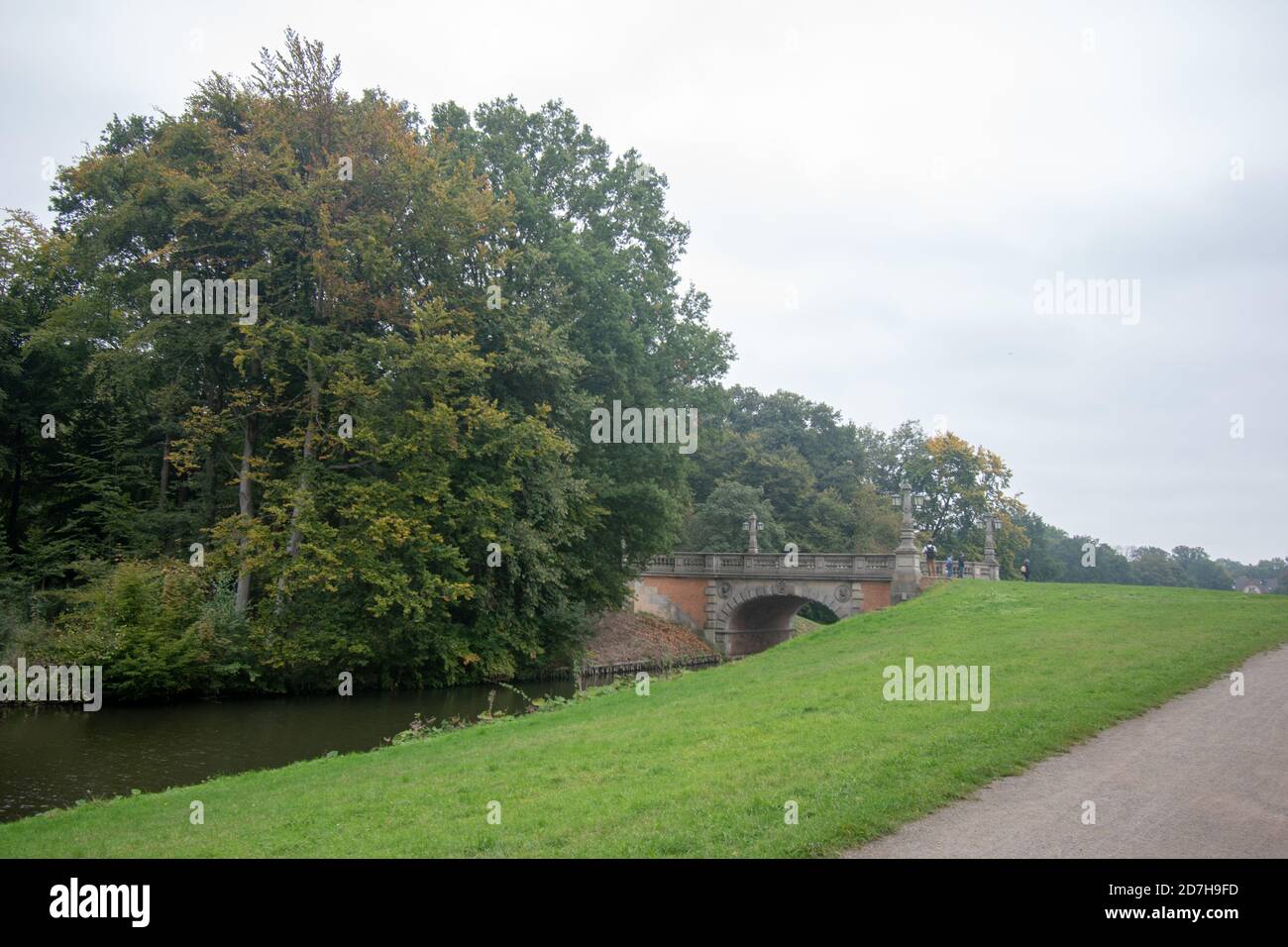 Bridge over a small lake surrounded by greenery in a Bremen park ...