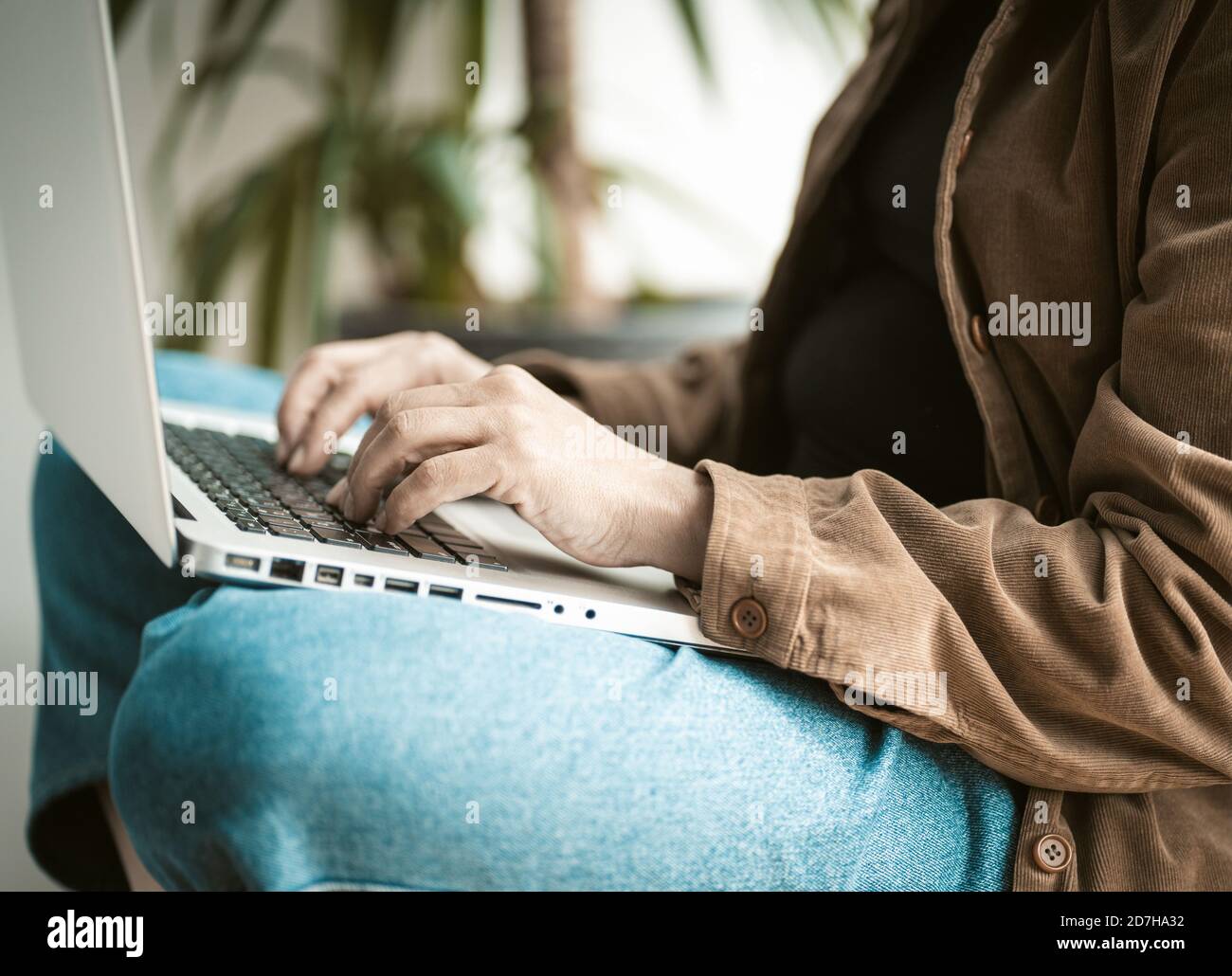 Freelancer woman works with laptop computer using internet while ...