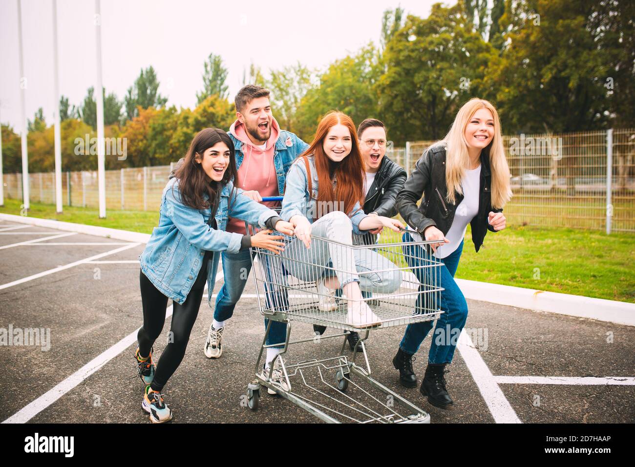 Unstoppable. Group of four young diverse friends in jeanse outfit look ...