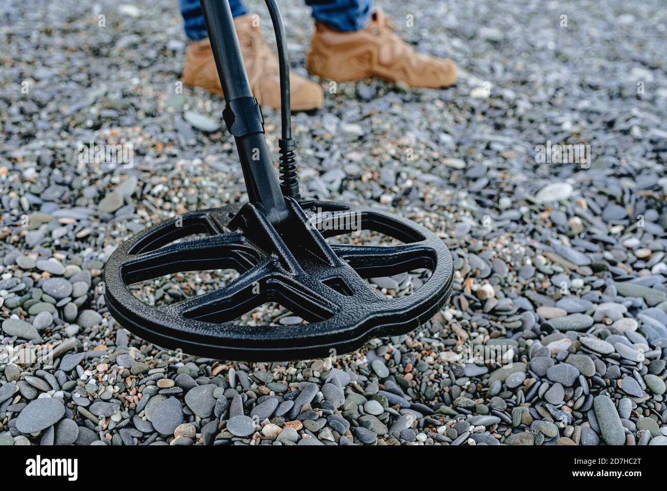 Metal detector coil in action above the ground Stock Photo - Alamy