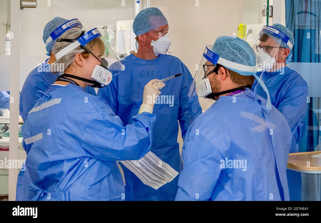 Health workers wearing full personal protective equipment (PPE) on the ...
