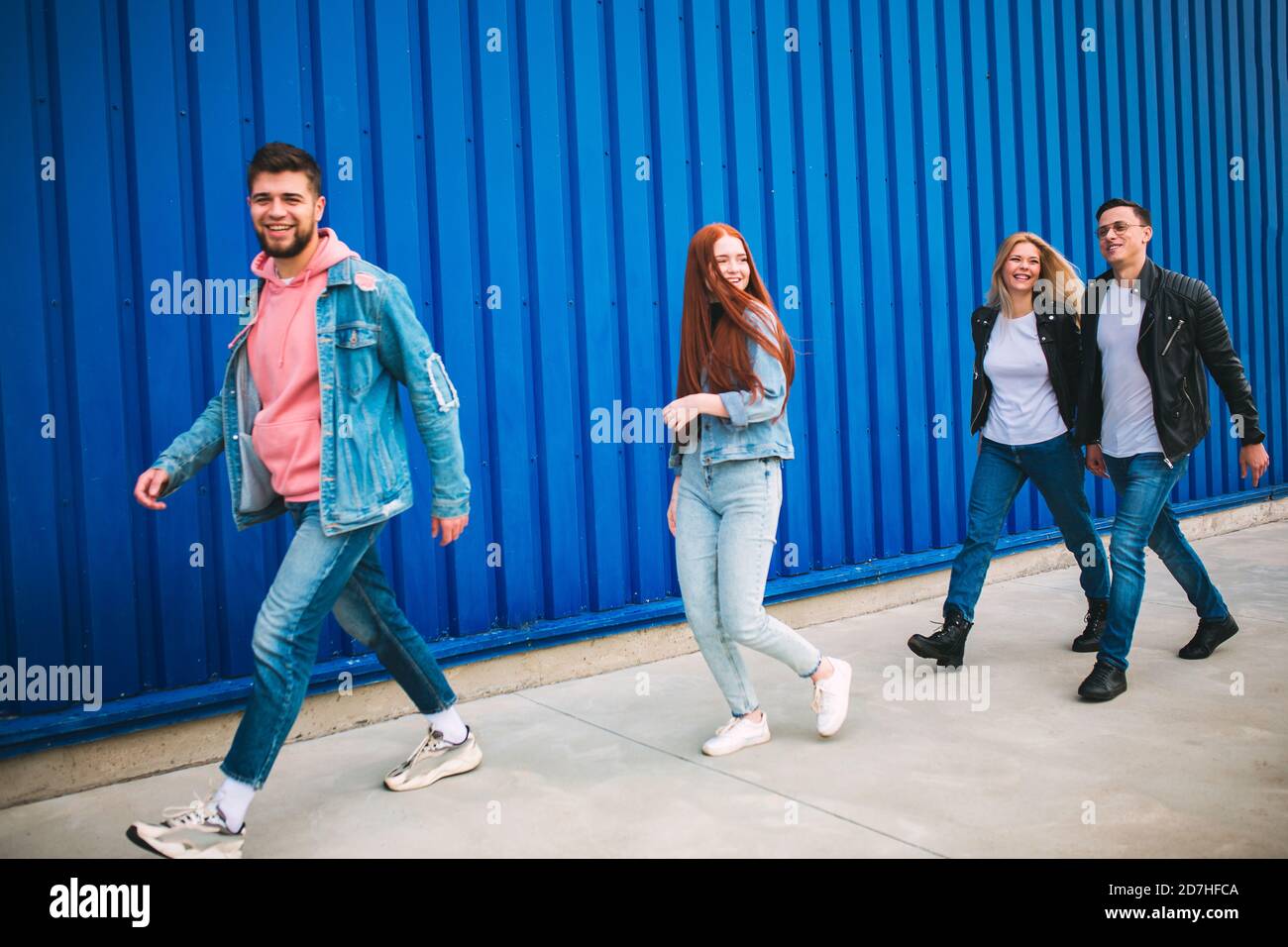 Forward. Group of four young diverse friends in jeanse outfit look ...