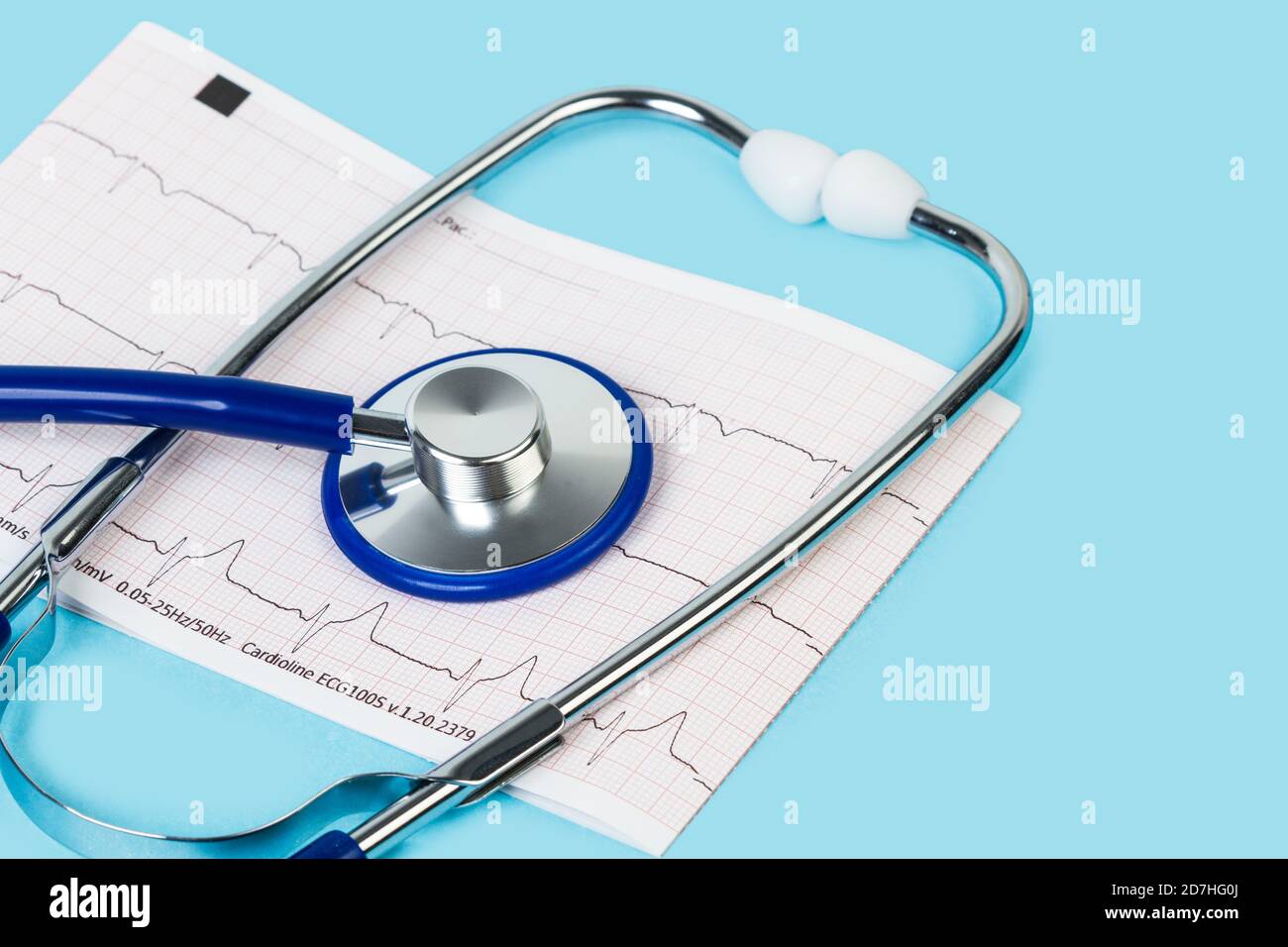 A stethoscope on an electrocardiogram result and on a light blue ...