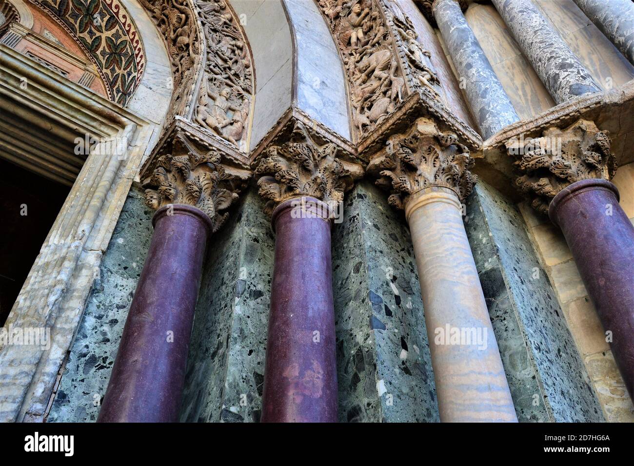 Ancient columns in St Mark's Basilica. Purple and green color columns ...