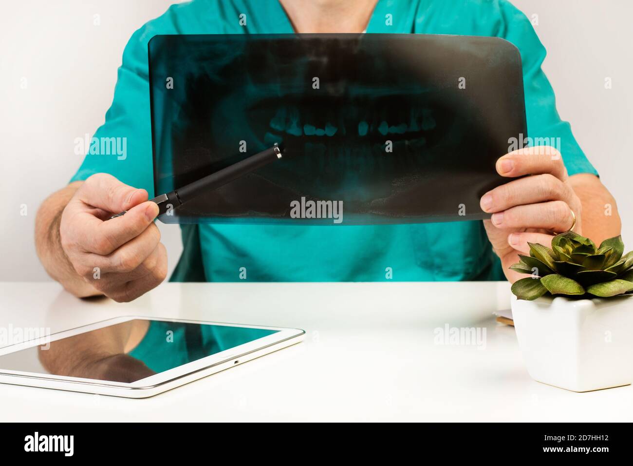 Dentist showing a radiography of a mouth with some teeth Stock Photo ...