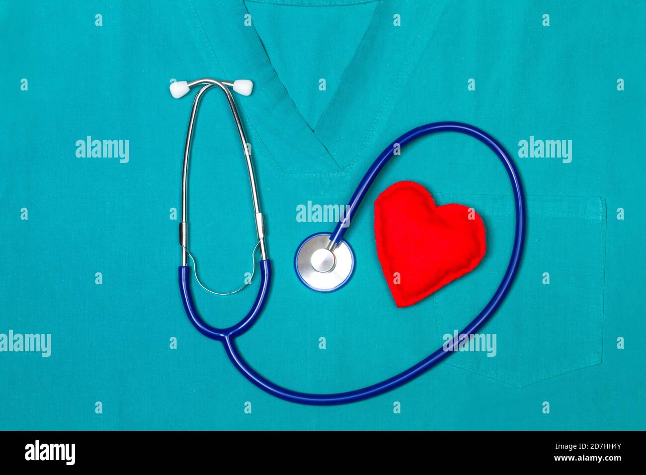 A stethoscope with a fabric red heart on a green medical uniform in a ...