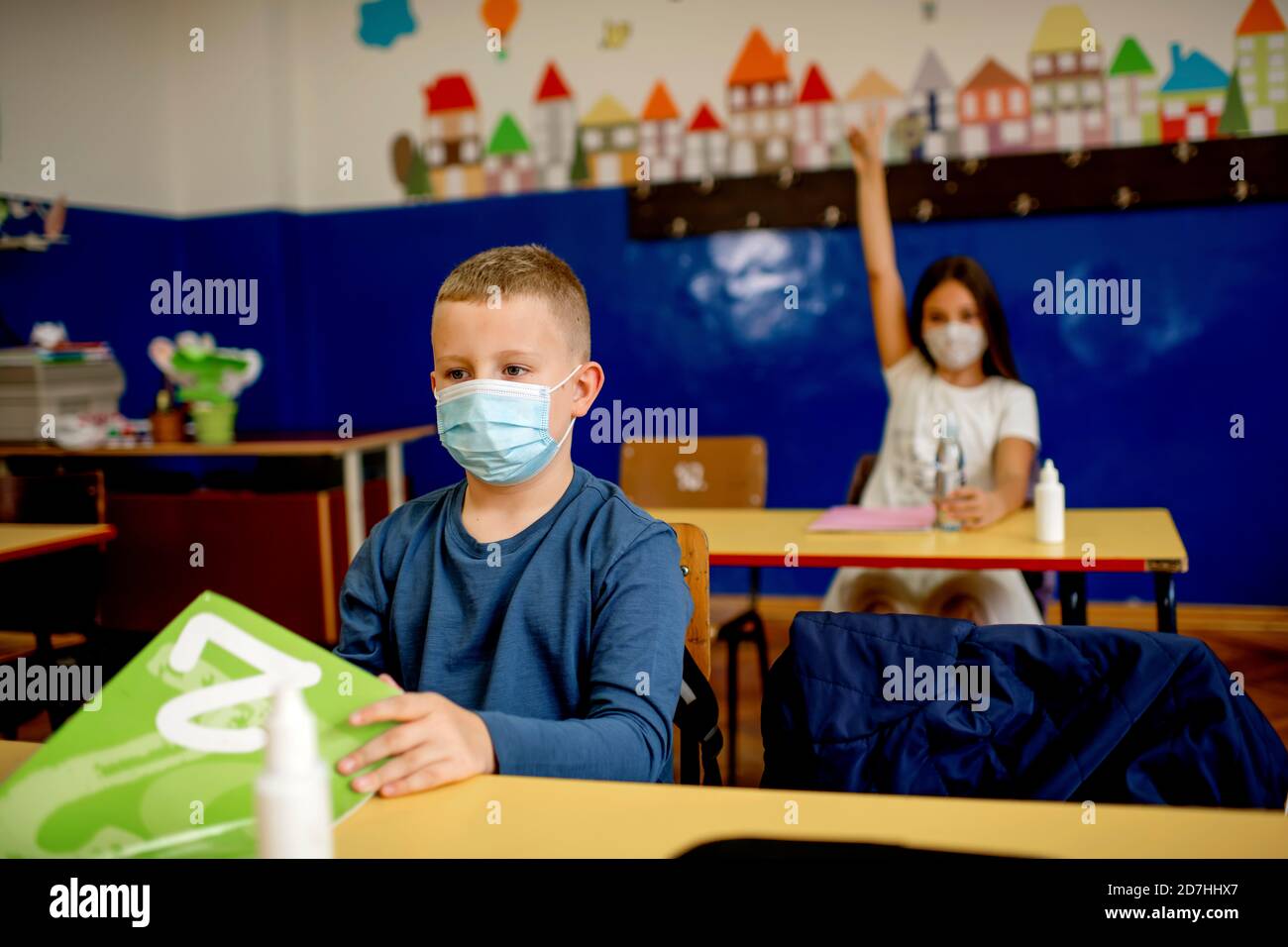 Elementary schoolchildren wearing a protective face masks in the ...