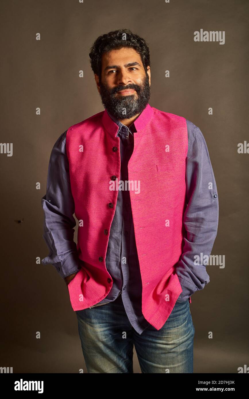 A young Indian man with a typical 'artist' and 'intellectual' look ...