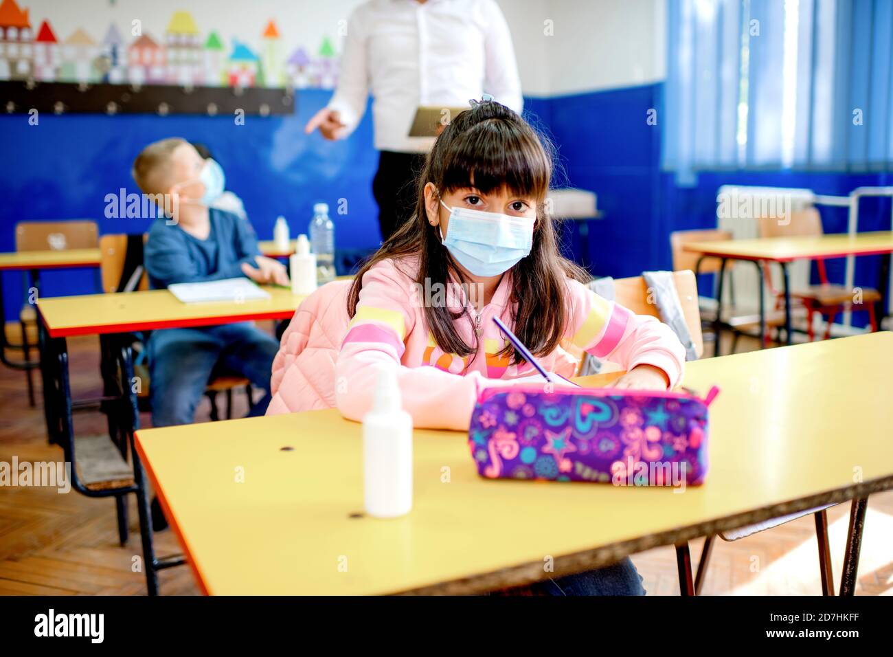 Elementary schoolchildren wearing a protective face masks in the ...