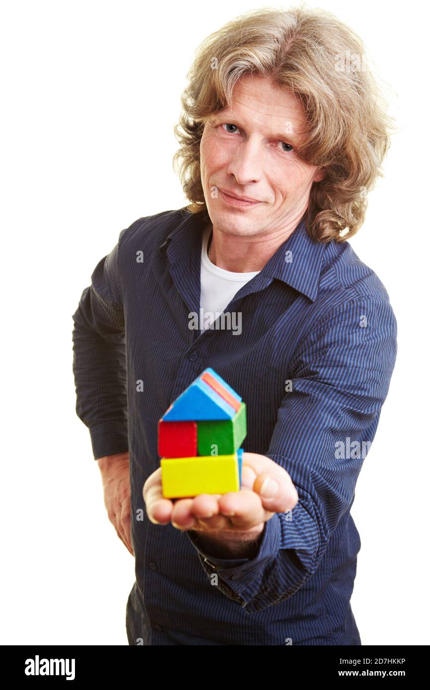 Man holds building blocks in house shape on his hand Stock Photo - Alamy