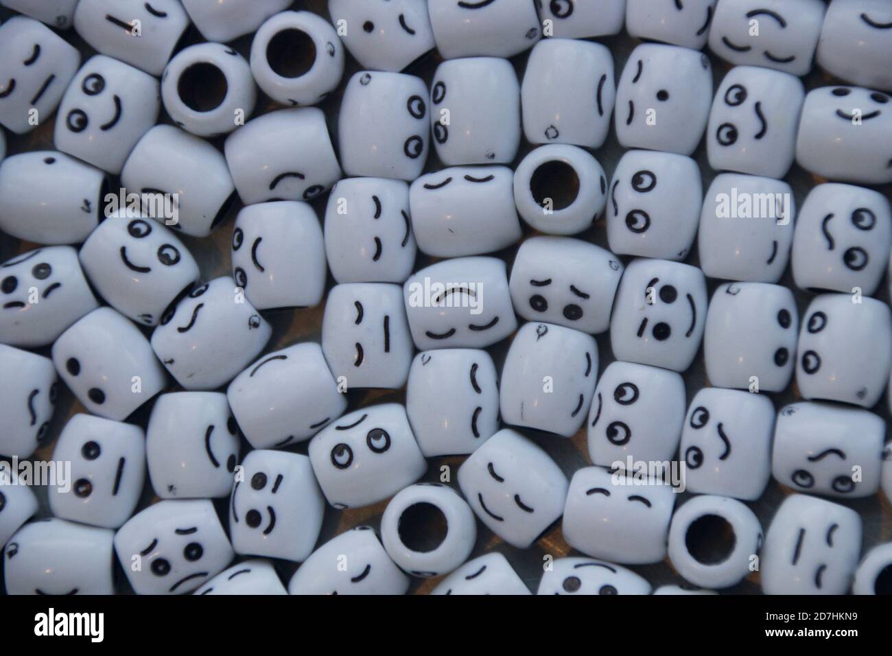 Cluster of white round shaped beads with smiles/faces Stock Photo - Alamy