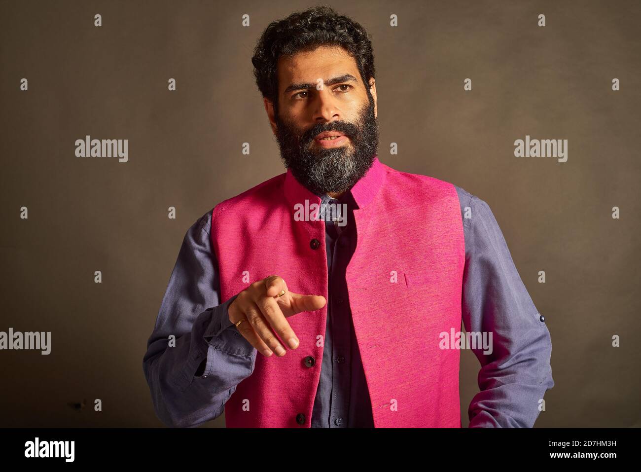 A young Indian man with a typical 'artist' and 'intellectual' look ...