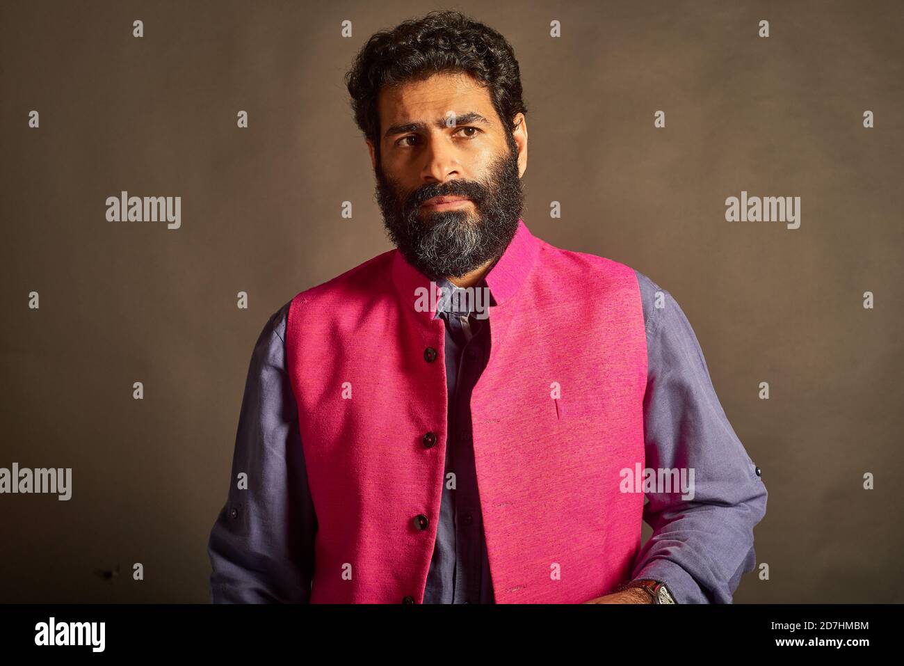 A young Indian man with a typical 'artist' and 'intellectual' look ...