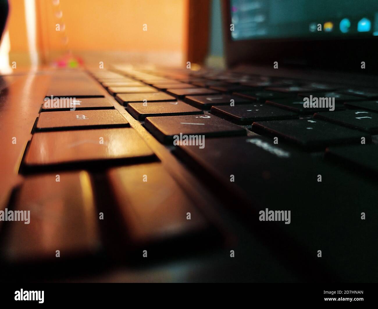 Low angle shot of black laptop keyboard while sunrise in sunny day ...