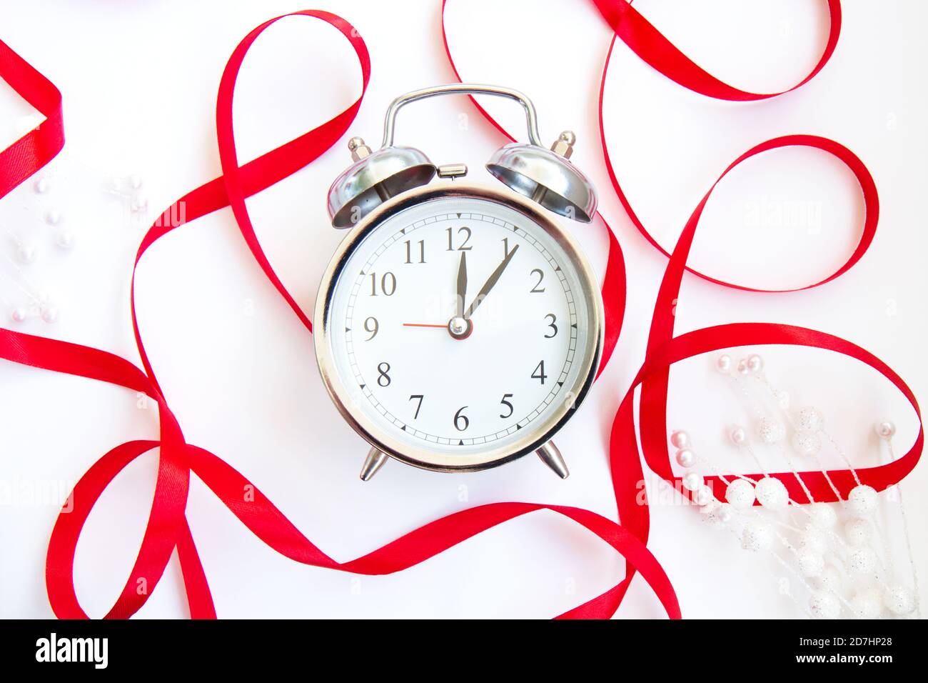 Bright festive red ribbon, curl and a beautiful vintage silver alarm ...