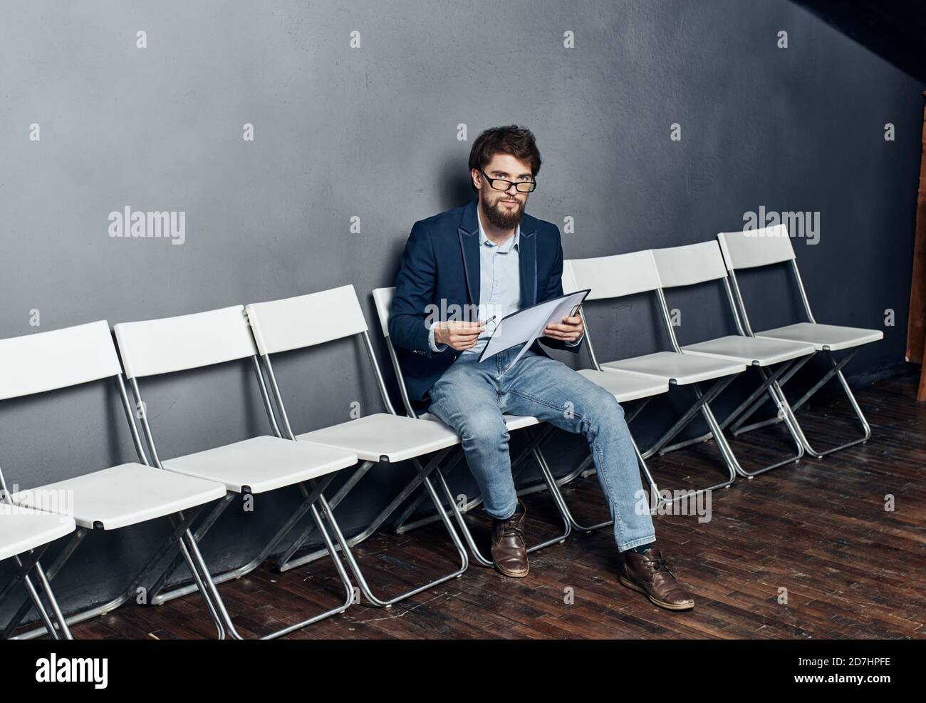 A man in a suit waiting for a job interview trying emotions Stock Photo ...
