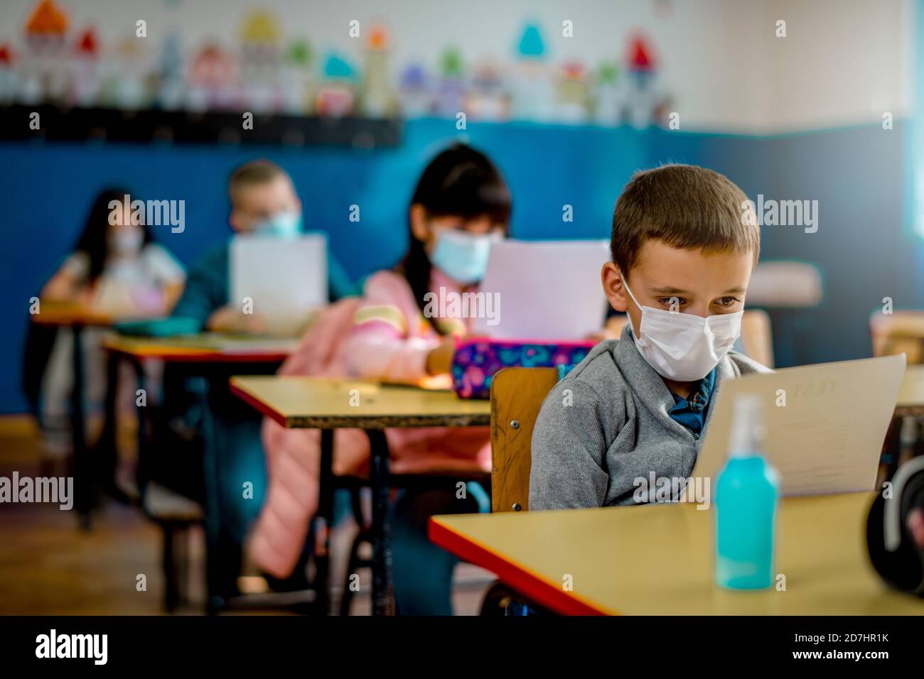 Elementary schoolchildren wearing a protective face masks in the ...