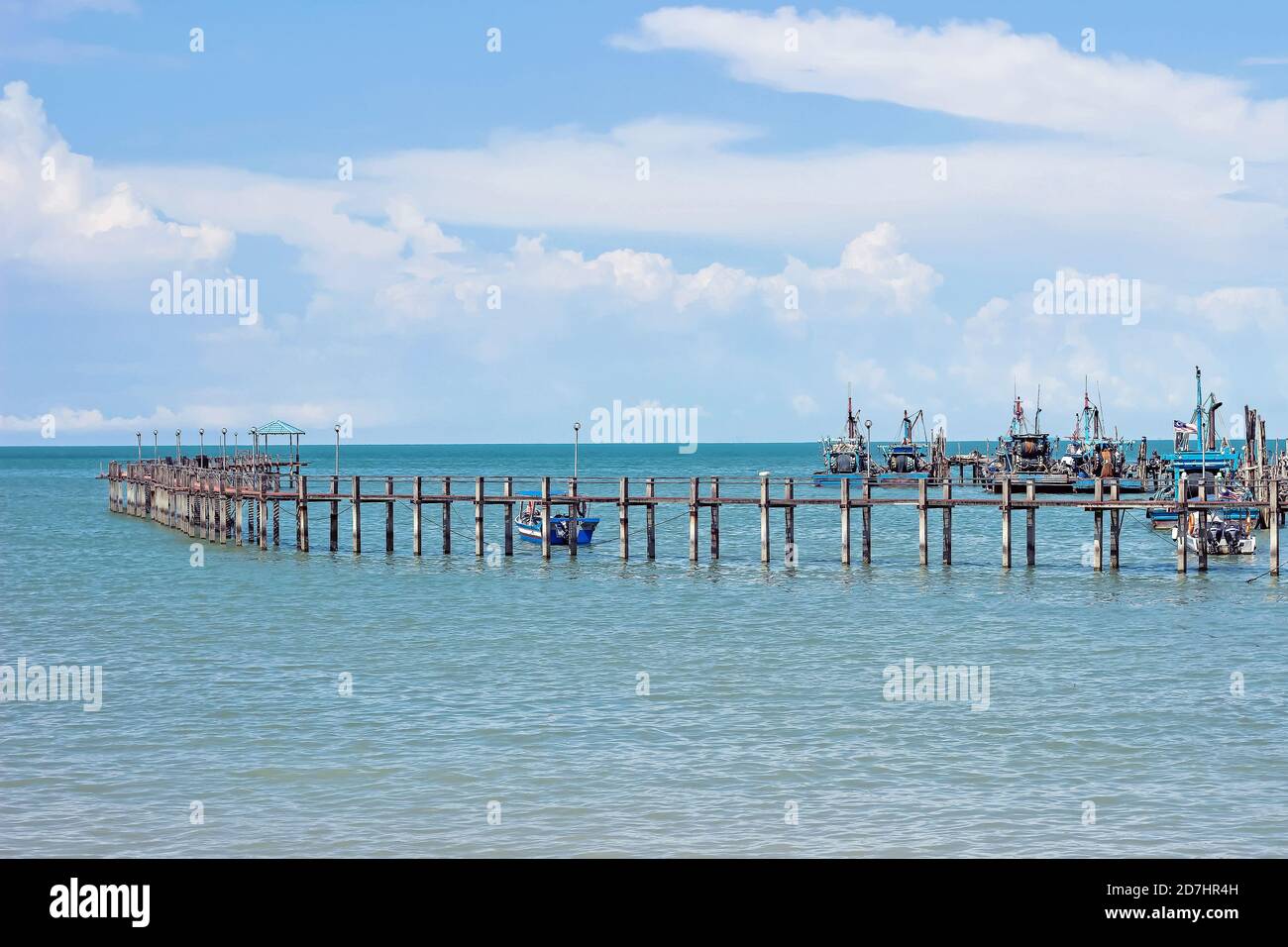 seascape with boat floating at dock in blue ocean Stock Photo - Alamy