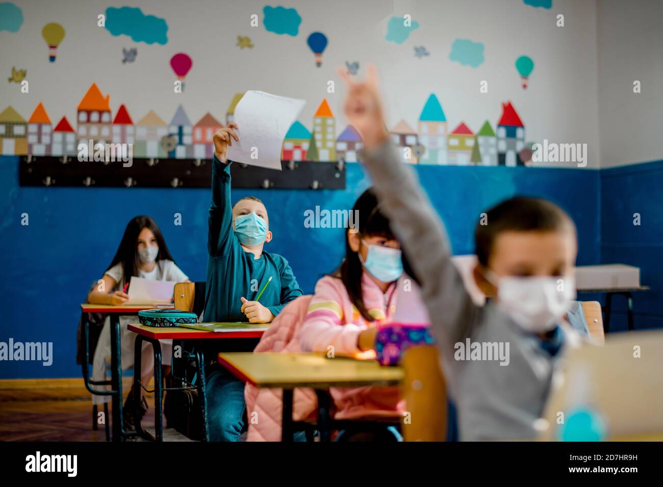 Elementary schoolchildren wearing a protective face masks in the ...