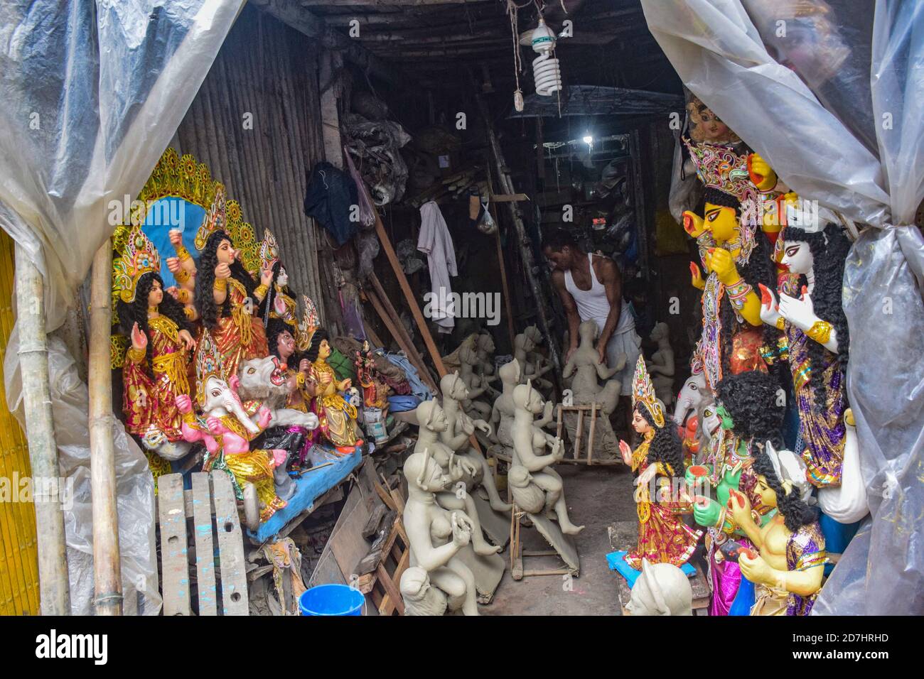 October 23, 2020, Kolkata, west bengal, india: An idol maker works beside his unsold Durga Idols ...