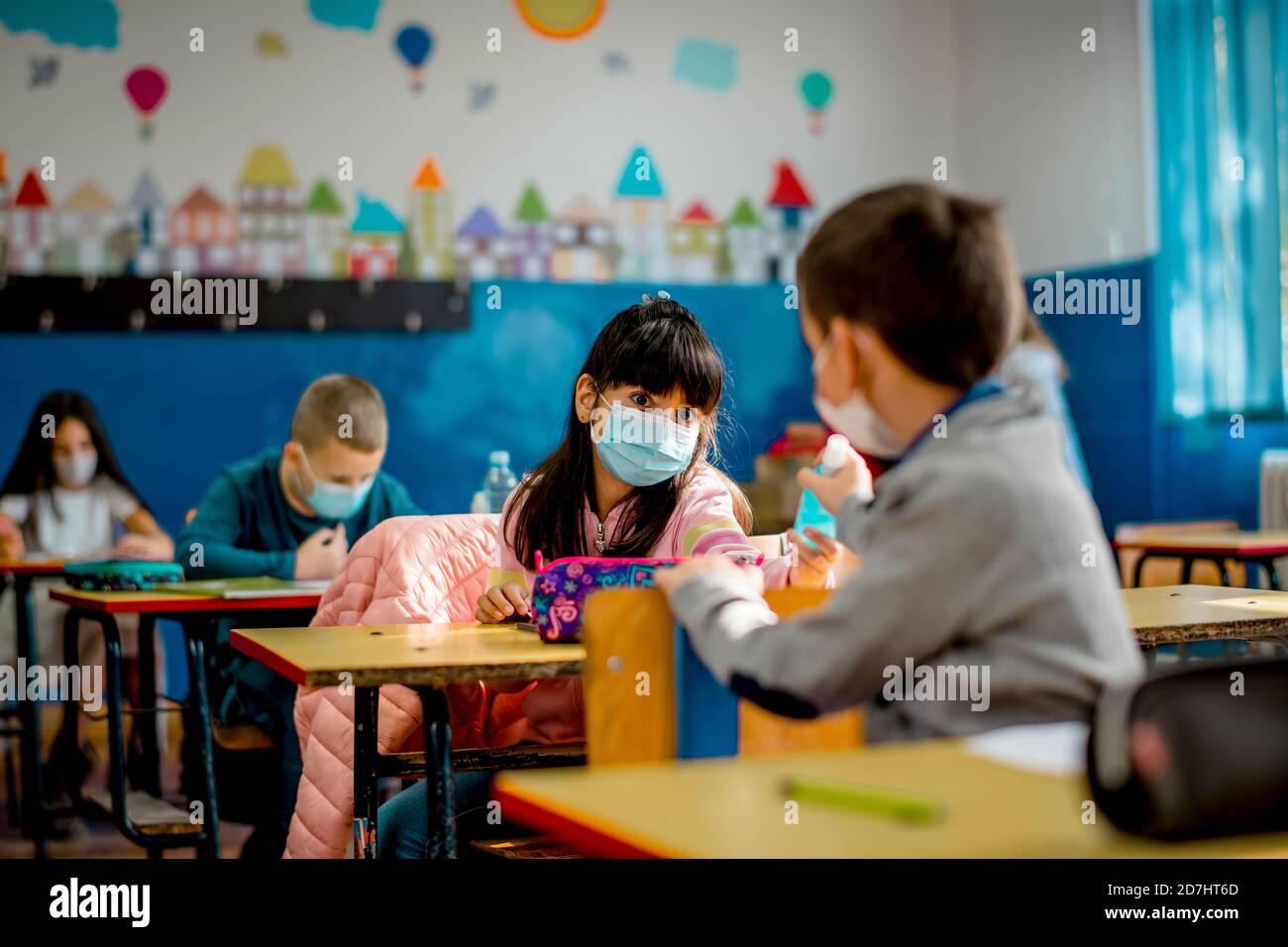 Elementary schoolchildren wearing a protective face masks in the ...