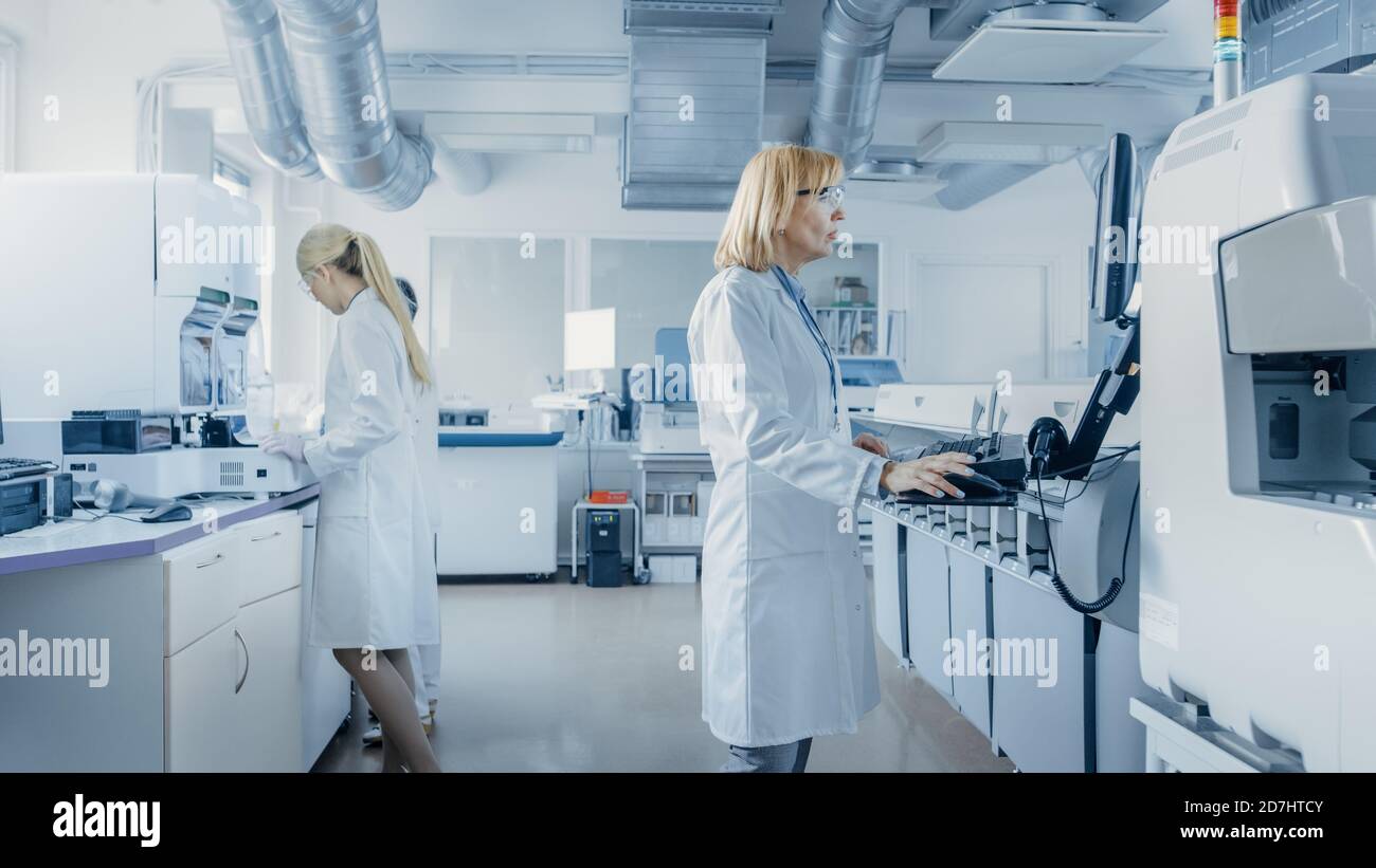 Team of Research Scientists Working On Computer, with Medical Equipment ...
