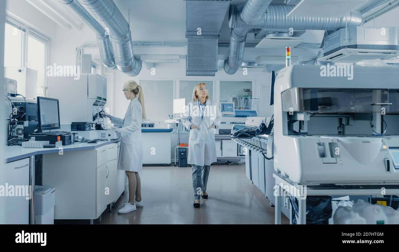 Team of Research Scientists Working On Computer, with Medical Equipment ...