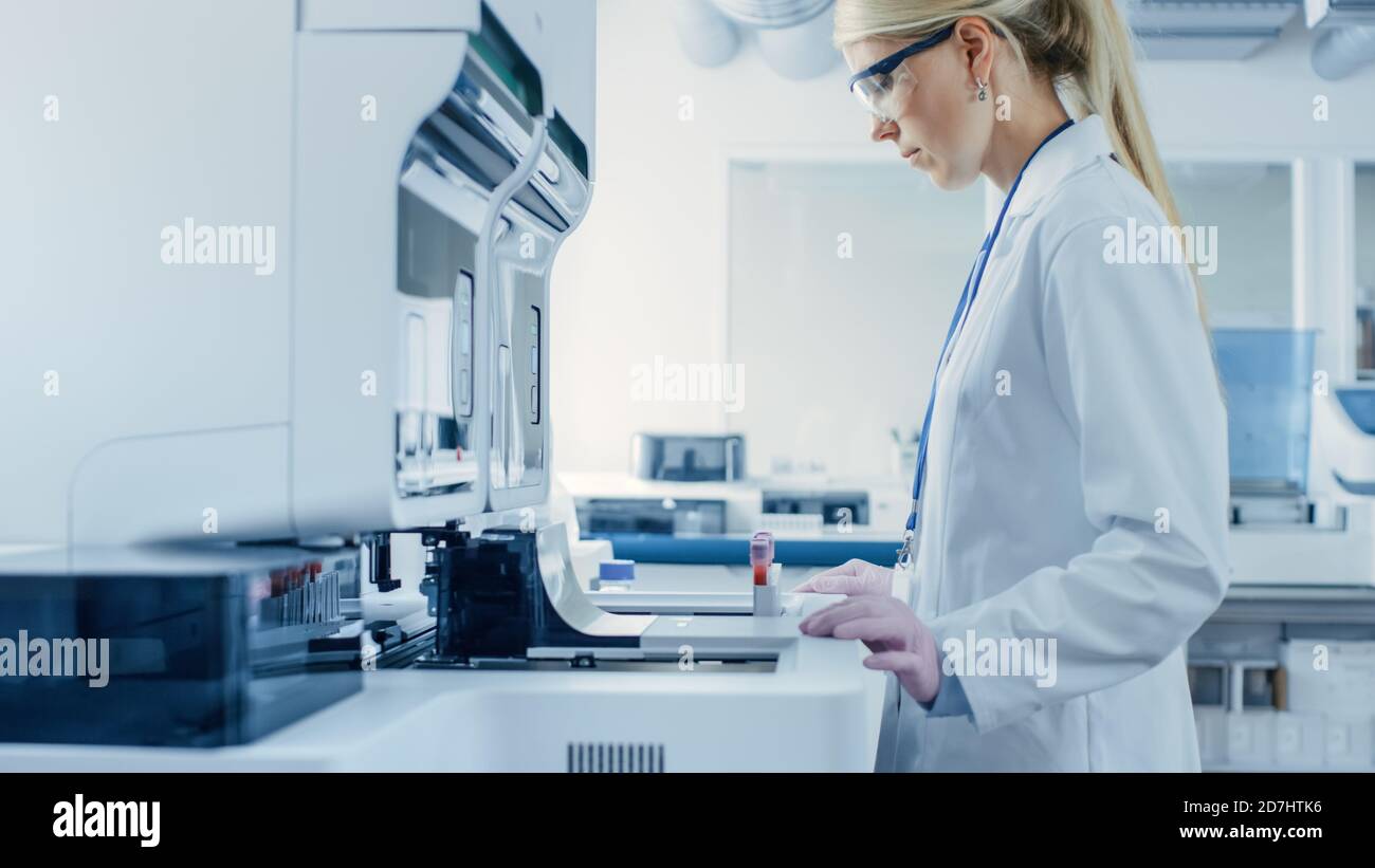 Female Research Scientist Putting Test Tubes with Blood Samples into ...