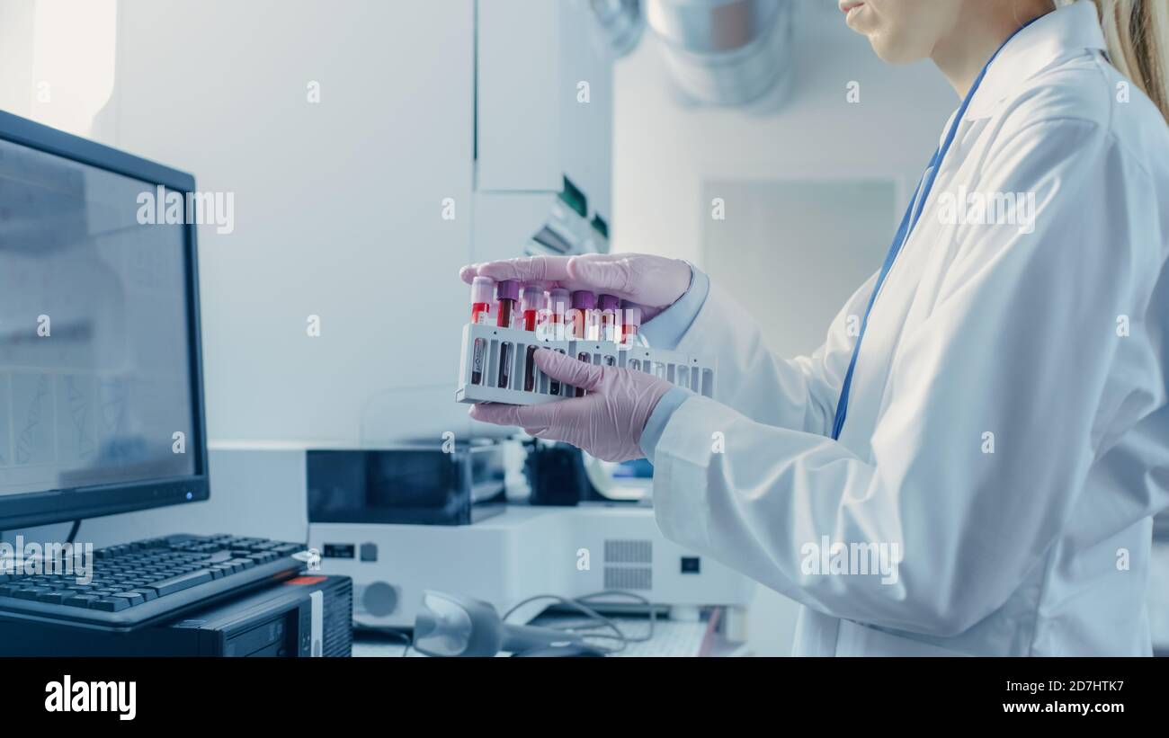 Female Research Scientist Holds Test Tubes with Blood Samples before ...