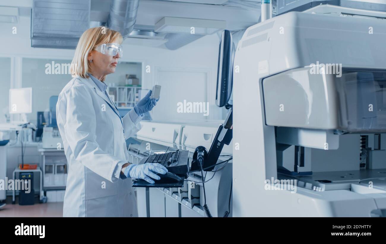 In Laboratory Female Scientist Analyzes Test Tube Data with Blood ...