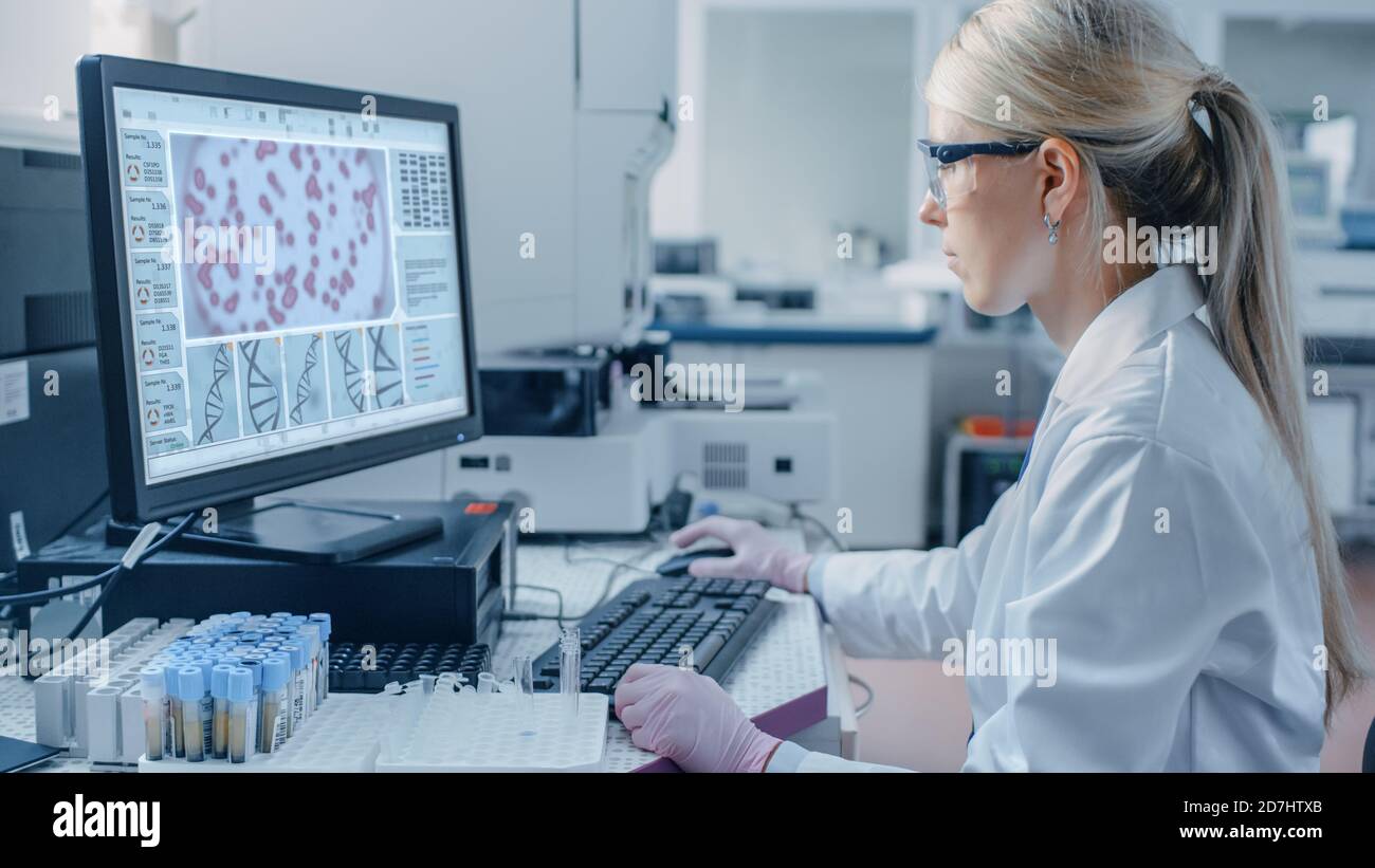 Female Scientist Sits at His Workplace in Laboratory, Uses Personal ...