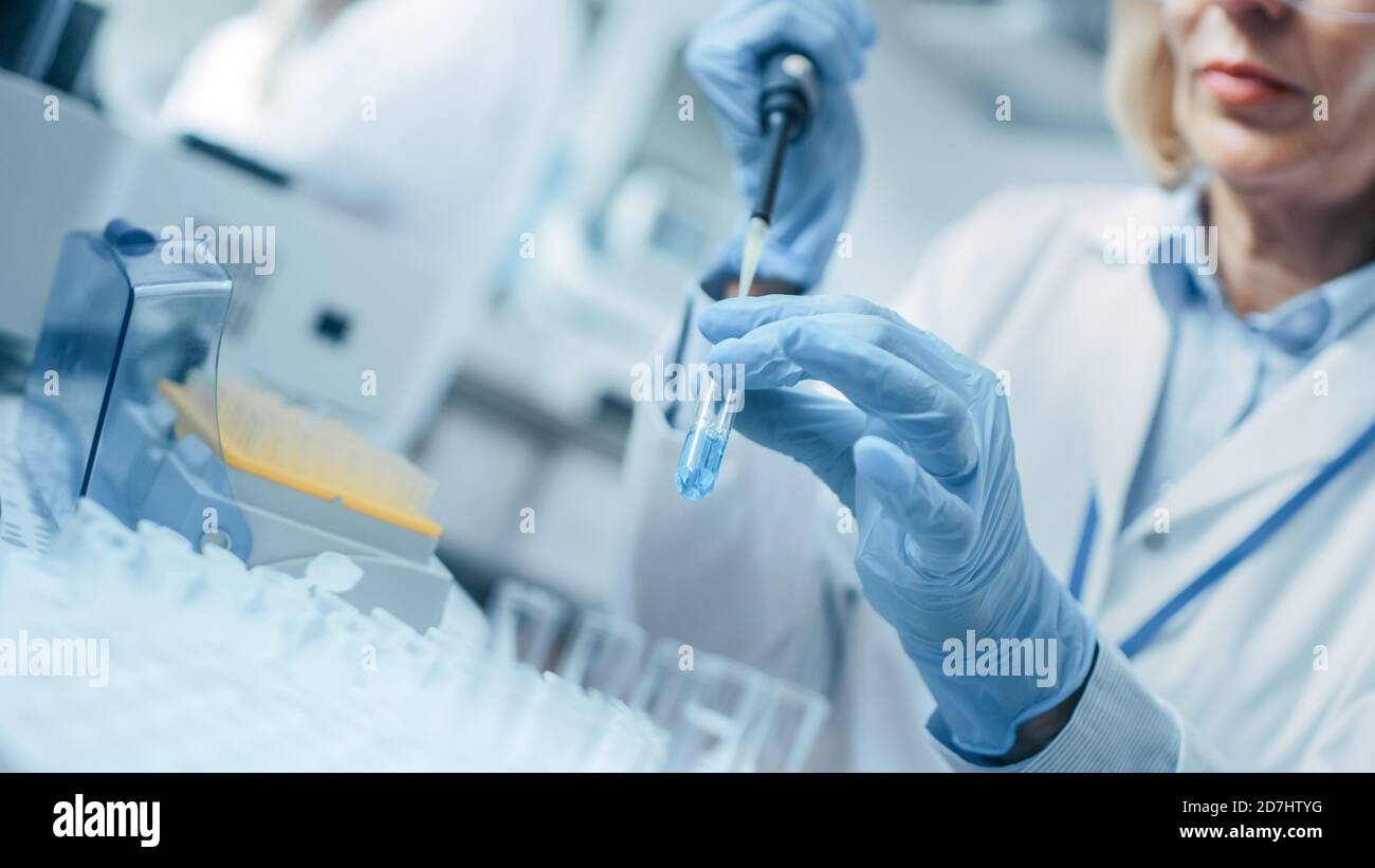 Close-up of the Hand in Glove Using Micro Pipette while Working with ...