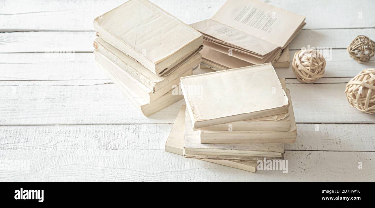 A large stack of books with a white cover on a large light table. The ...