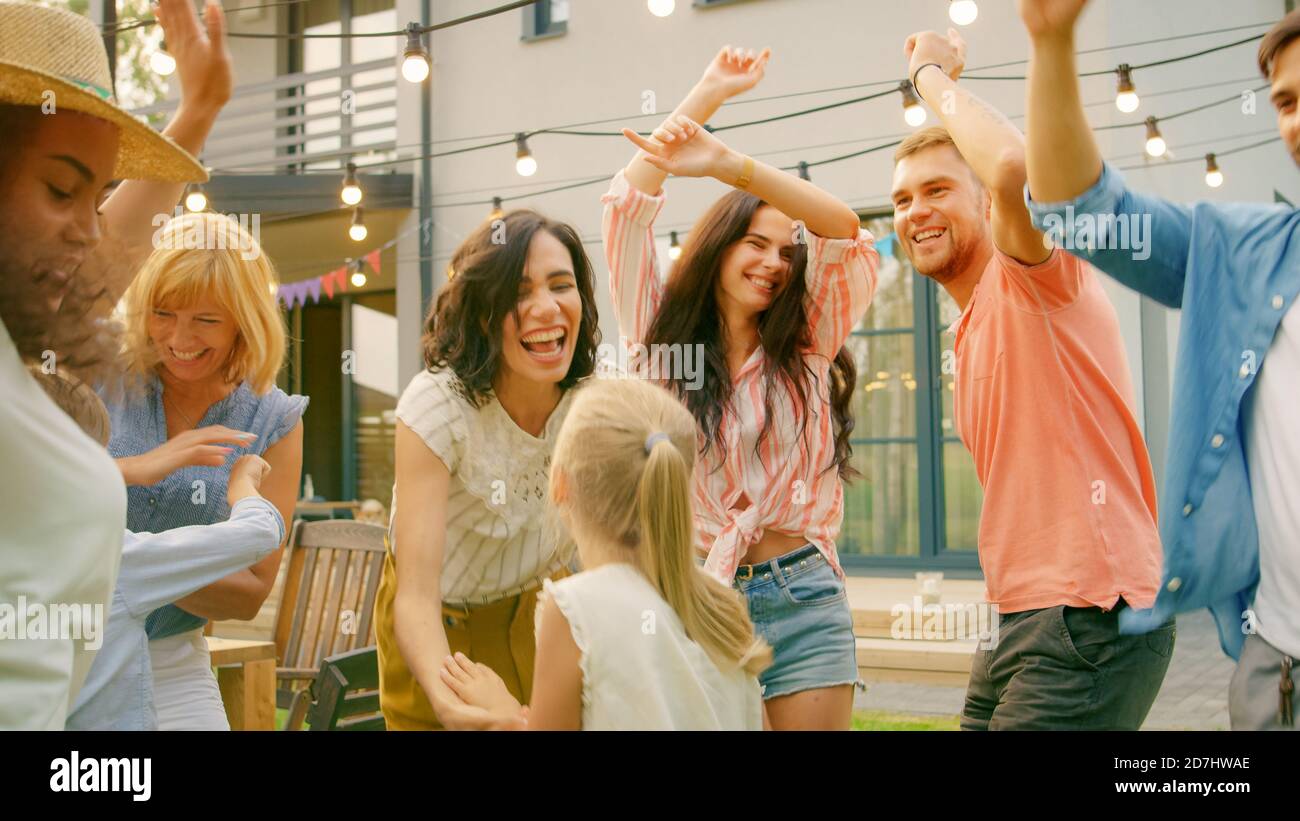 Family and Friends Dancing together at the Garden Party Celebration ...