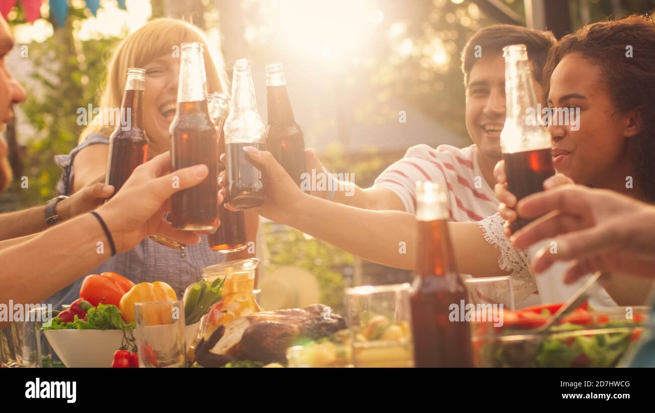 Family and Friends Gathered Together at the Table Raise Glasses and ...