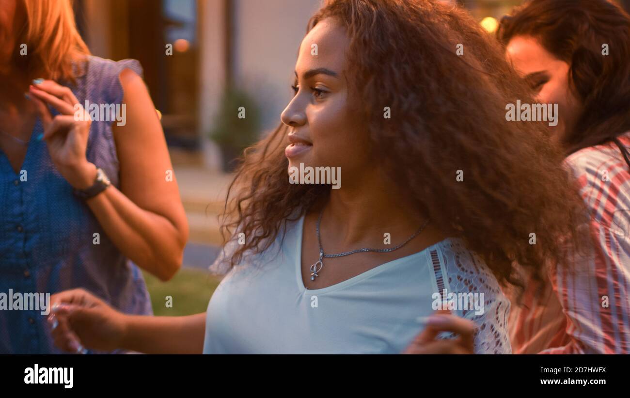 Beautiful Black Girl Dances with Friends at the Evening Party. Young ...