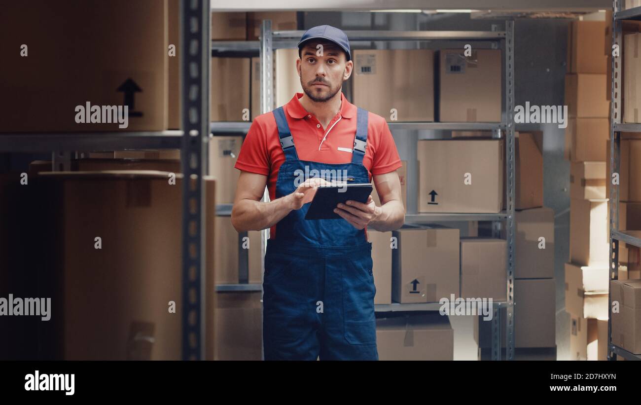 Warehouse Worker Uses Digital Tablet For Checking Stock, On the Shelves ...