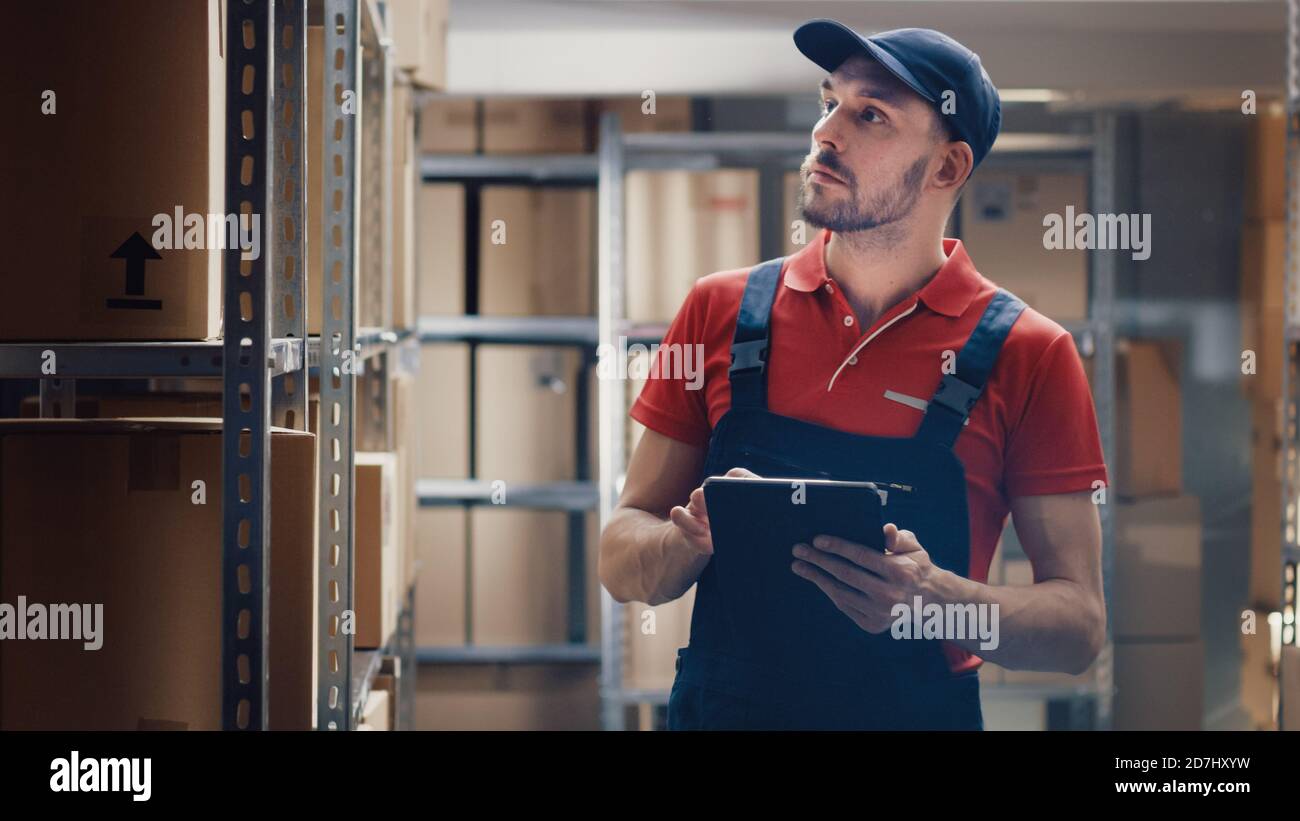 Warehouse Worker Uses Digital Tablet For Checking Stock, On the Shelves ...