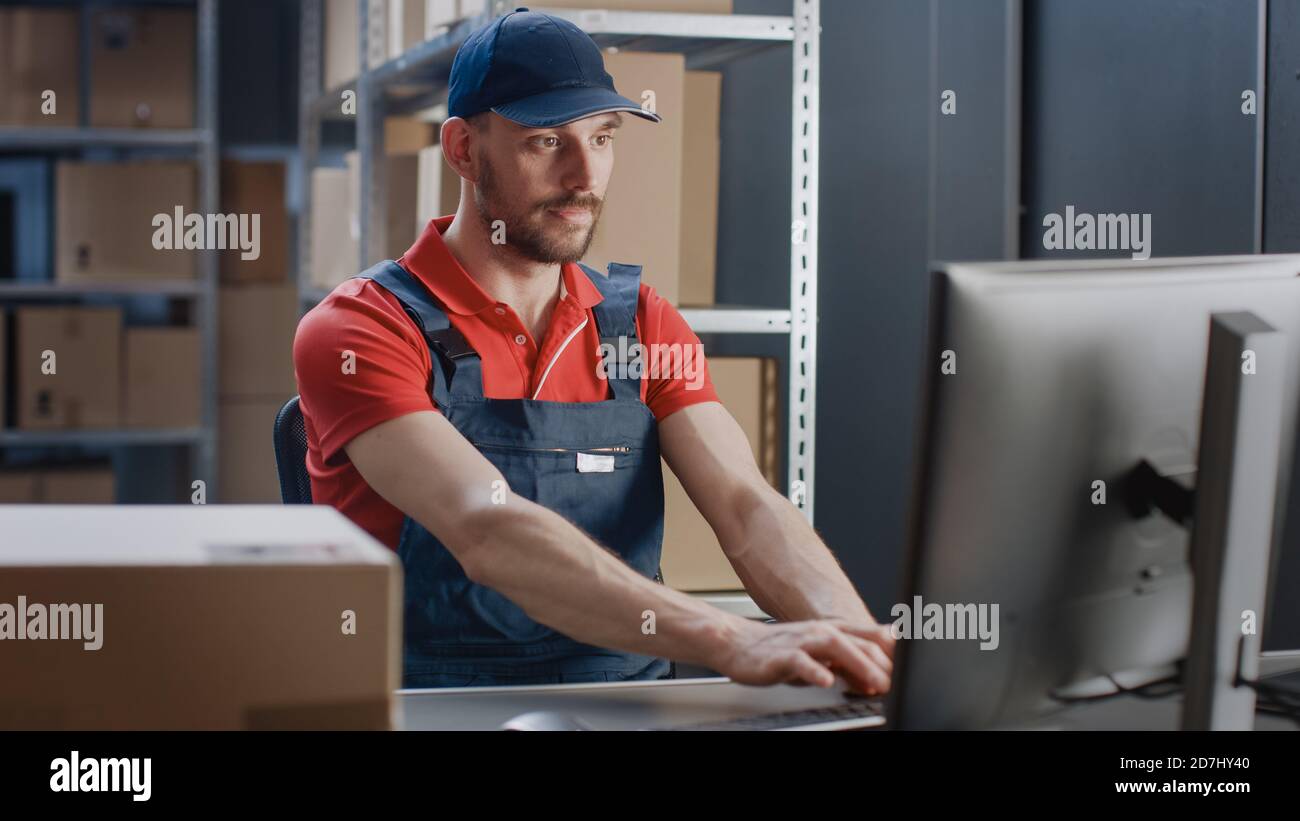Portrait of Uniformed Worker Using Personal Computer while Sitting at ...