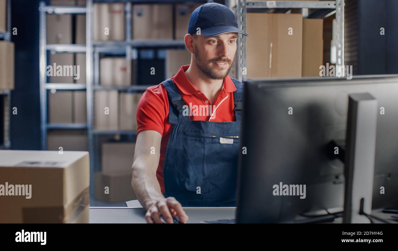Portrait of Uniformed Worker Using Personal Computer while Sitting at ...