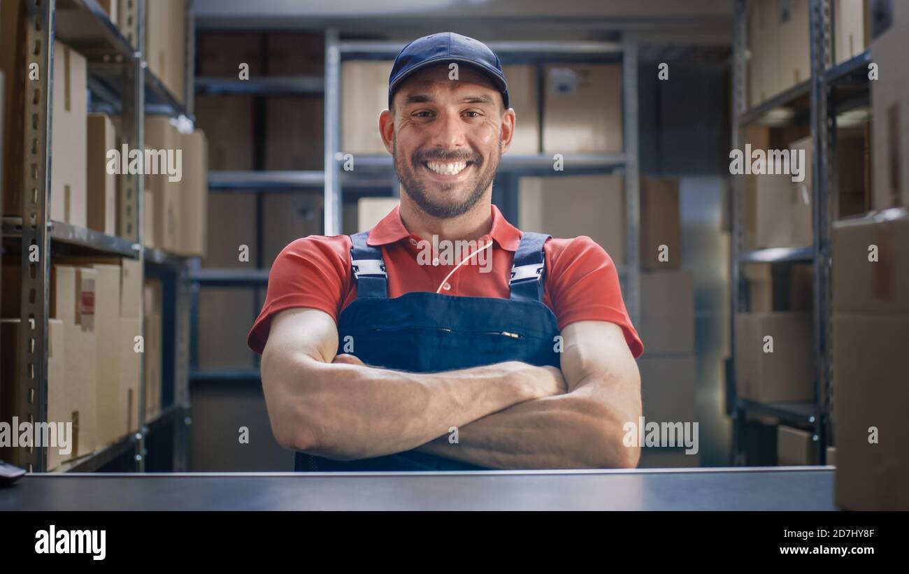 Warehouse Worker Wearing Uniform Crosses Arms and Smiles Stock Photo ...