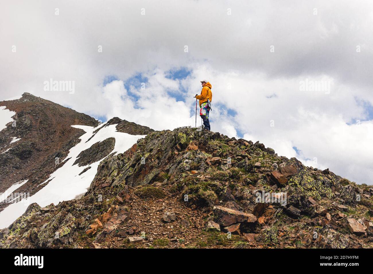 Man adventurer traveler on cliff above clouds travel hike in mountains ...
