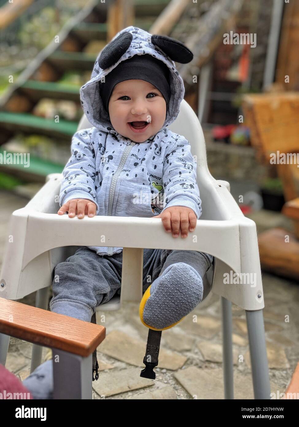 Happy boy sitting in a chair laughing Stock Photo - Alamy